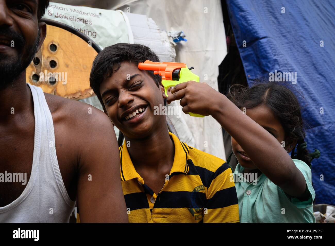 Kids clowning with a toy gun, Chennai, India Stock Photo - Alamy