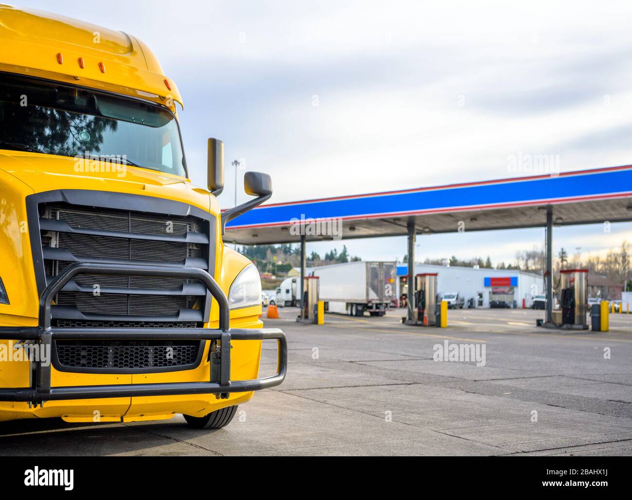 Big rig yellow long haul industrial diesel semi truck with grille guard ...