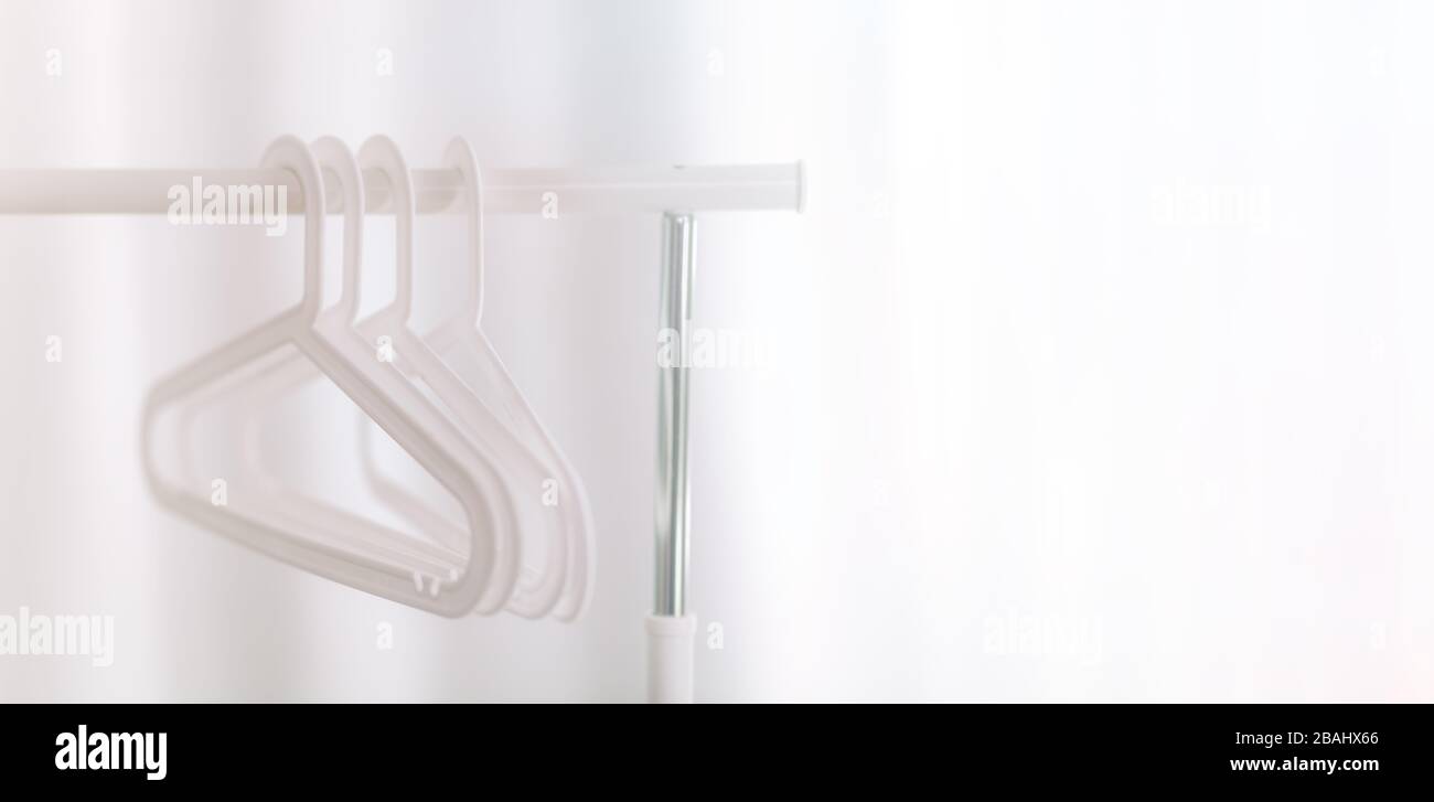 Stylish white hangers Stock Photo - Alamy