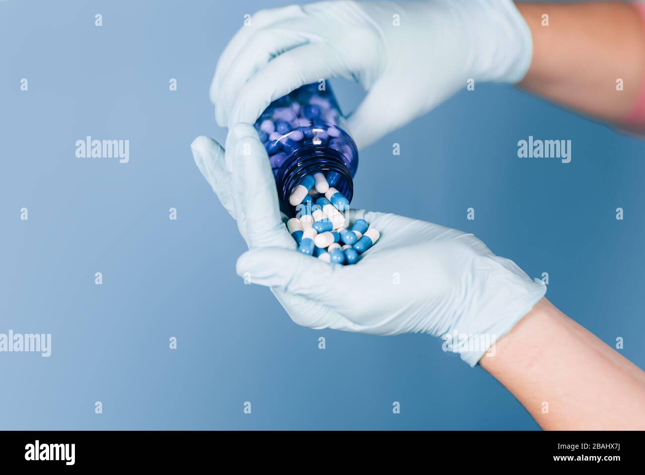 Young doctor holding pill container hi-res stock photography and images ...
