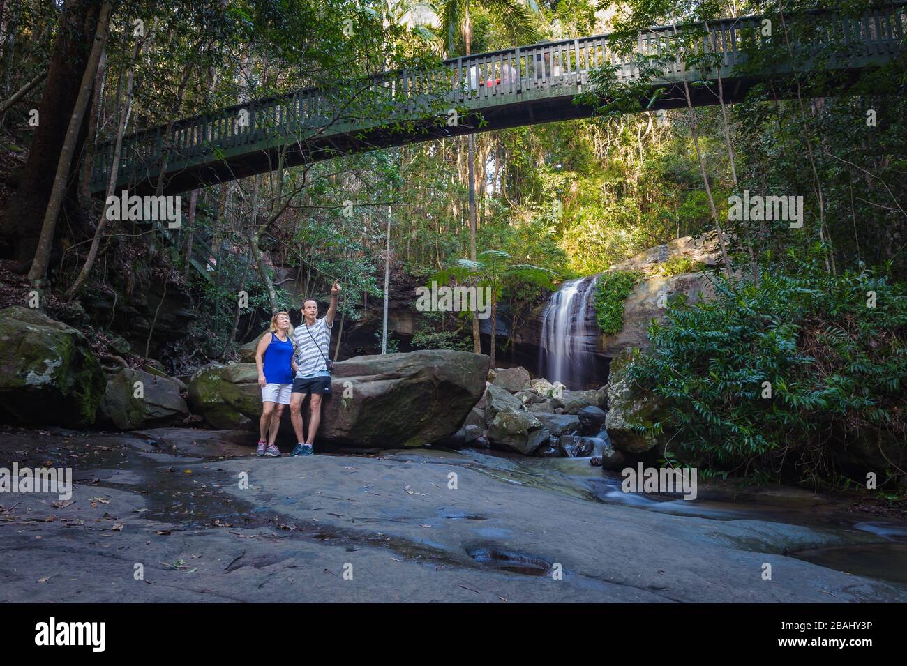 Couple standing under waterfall hi-res stock photography and images - Alamy