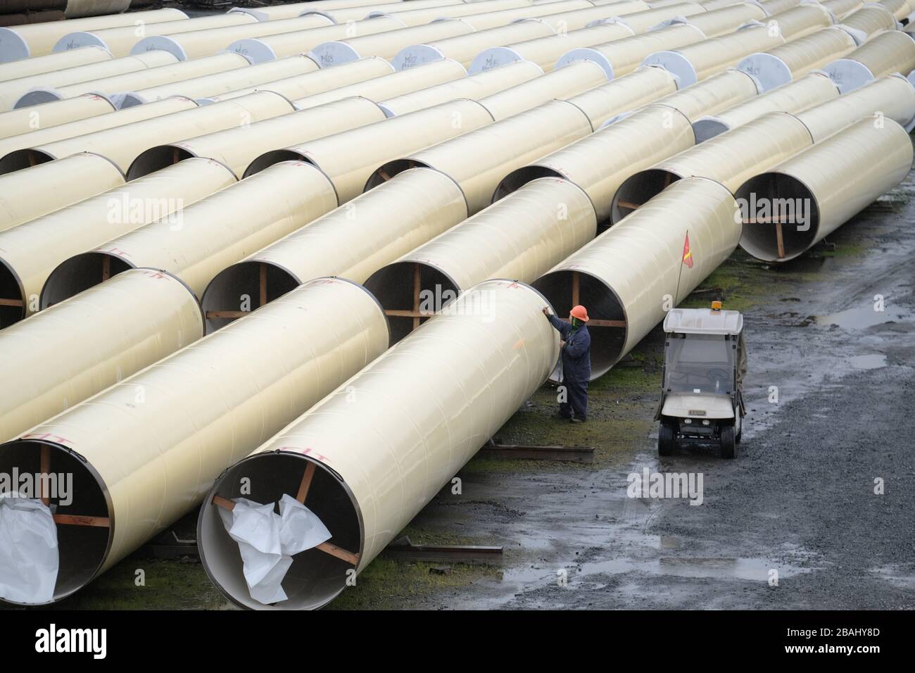 Portland, USA. 27th Mar, 2020. A worker labels large diameter high ...
