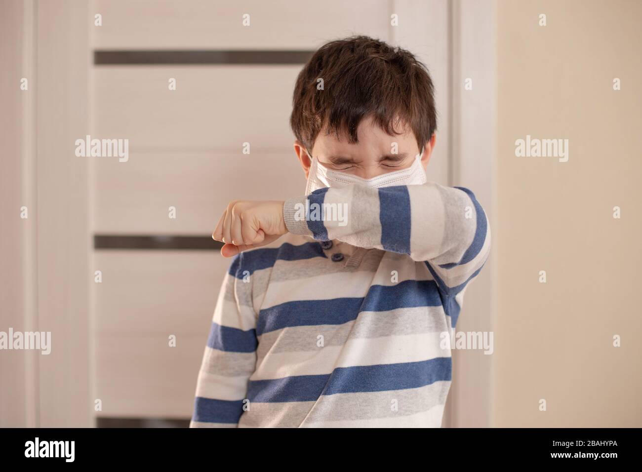 Child Coughing Into Elbow