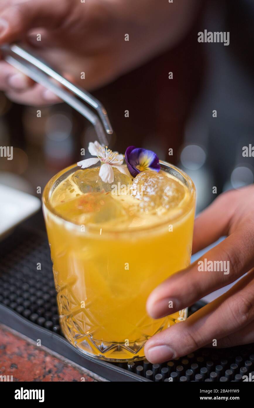 Bartender places decoration to finish the drink Stock Photo - Alamy