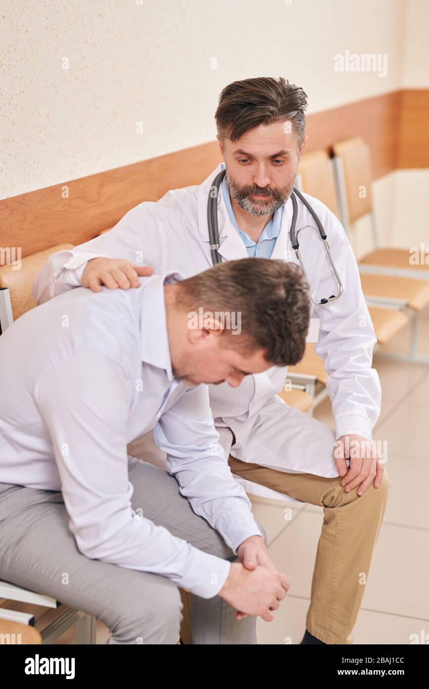 Nurse consoling relative hi-res stock photography and images - Alamy