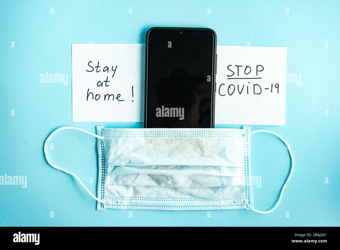 COVID-19 virus concept with cell phone on blue pastel background with ...