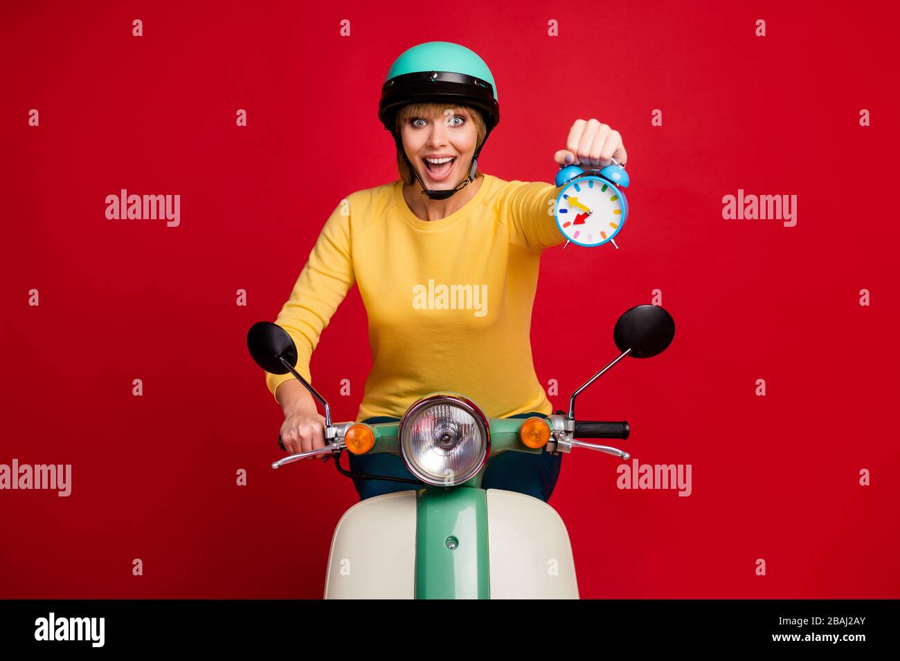Portrait of excited energetic girl ride her fast speed motorbike hold ...