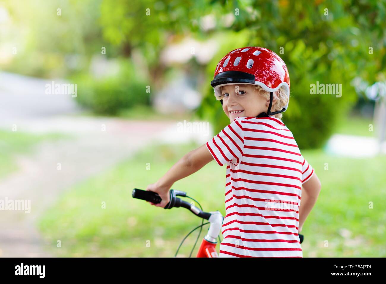 Kids on bike in park. Children going to school wearing safe bicycle ...