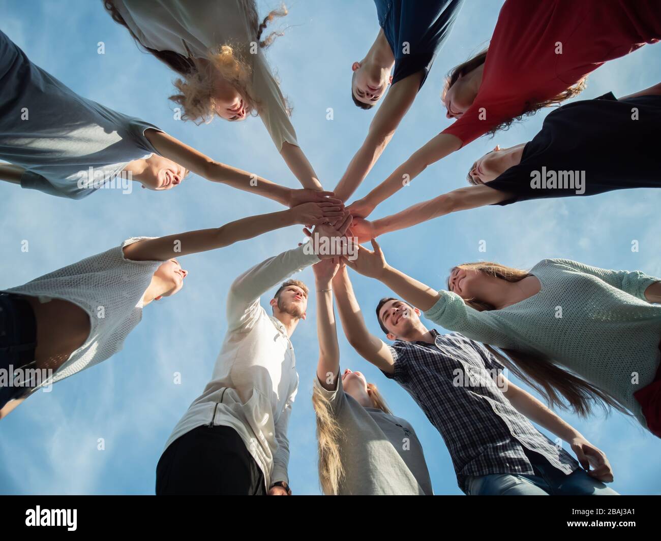 Friendly friends join hands as a sign of joint business. The concept of ...