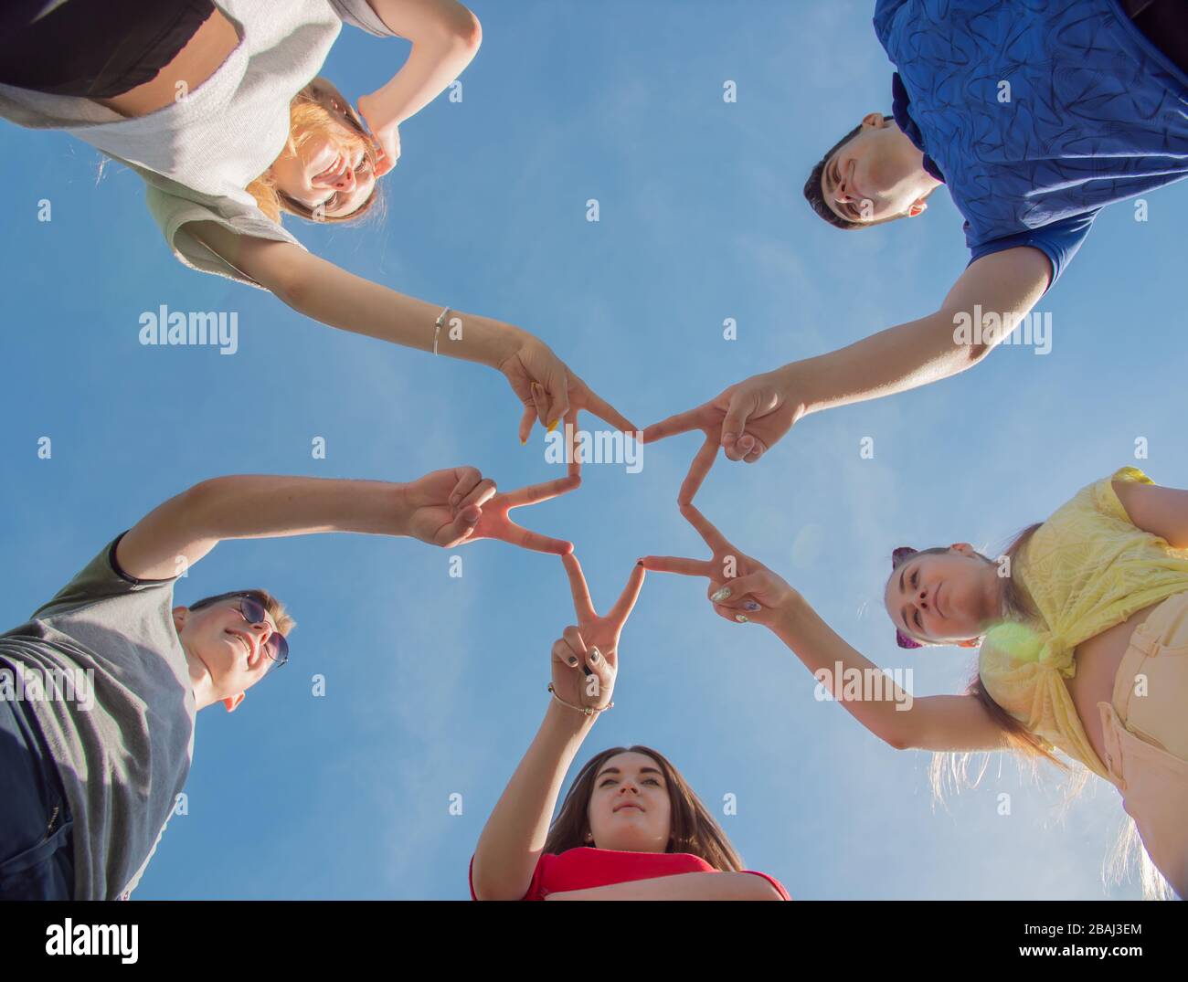 Friends make a star shape from their hands Stock Photo - Alamy