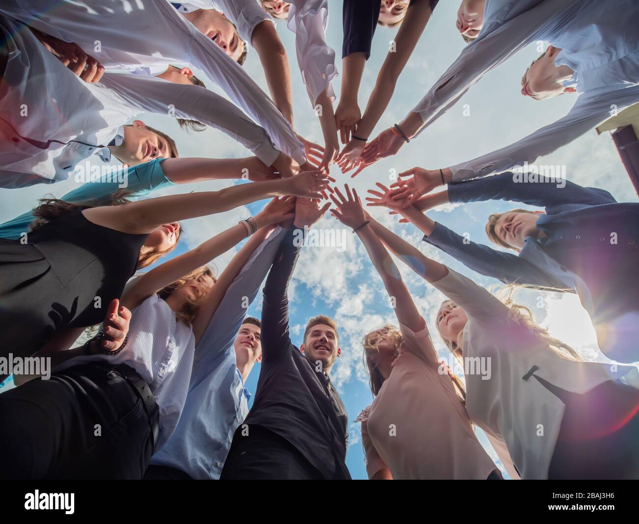 A friendly company of friends join hands as a sign of joint business ...