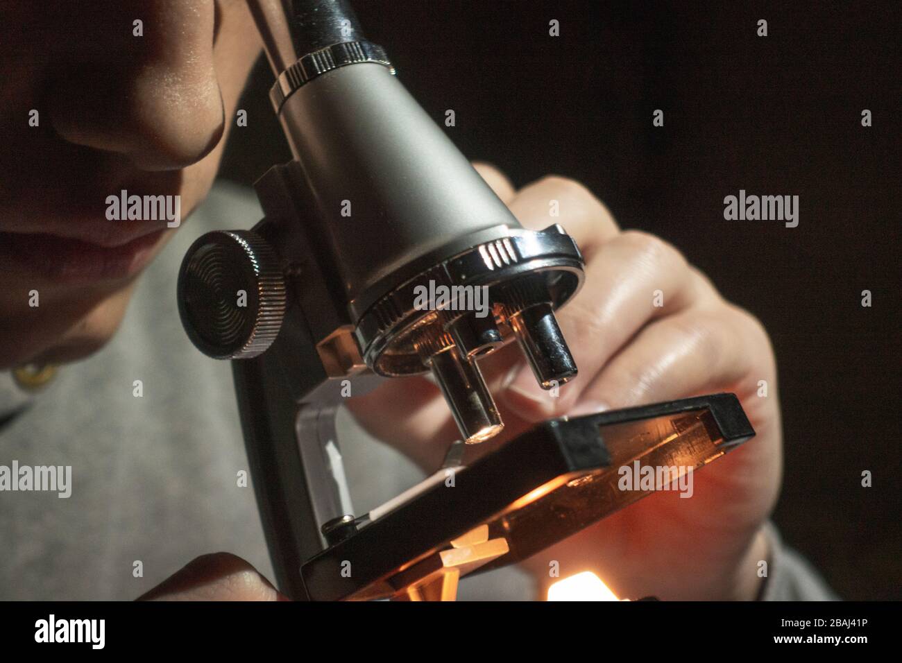 Man looking through microscope hi-res stock photography and images - Alamy