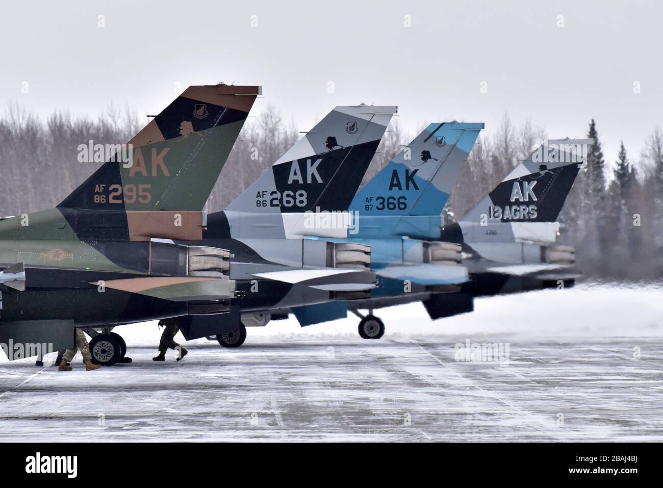 Four F-16 Fighting Falcons from the 18th Aggressor Squadron sit on the ...