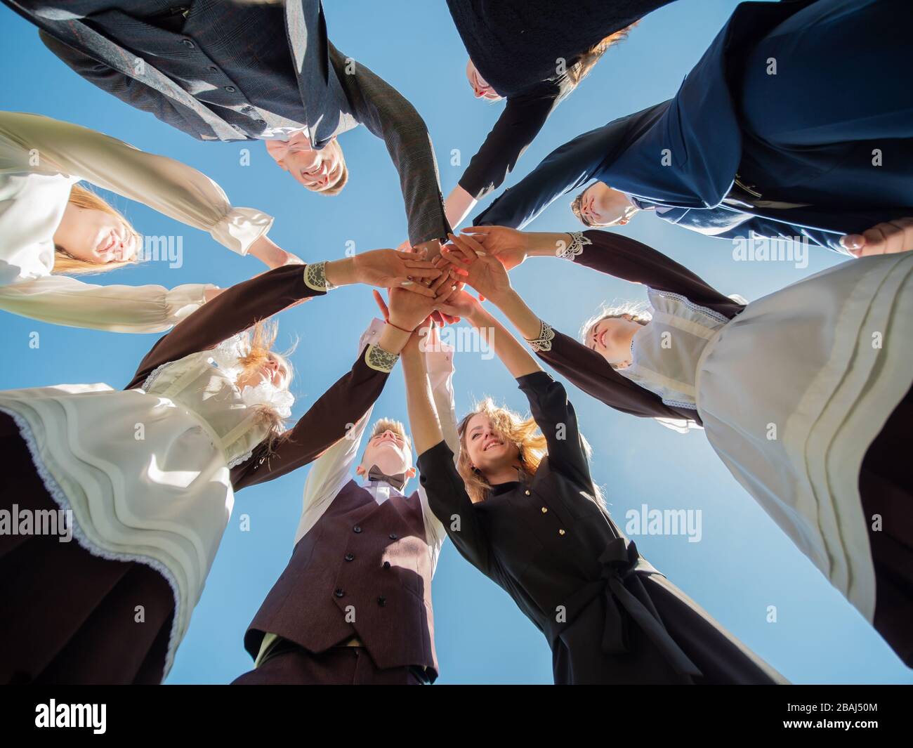High school students join hands in a sign of strong friendship and ...