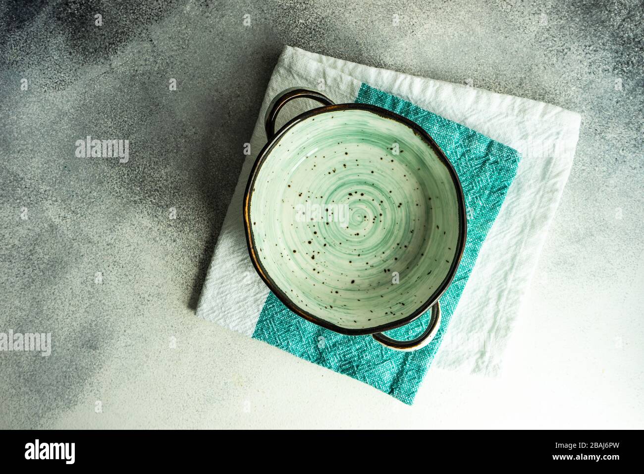 Tableware concept with ceramic bowl on stone background with copy space ...