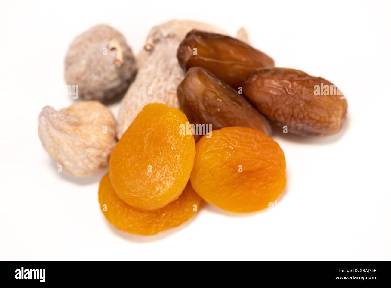 Dried fruit composition, figs, apricots, dates, on white background ...