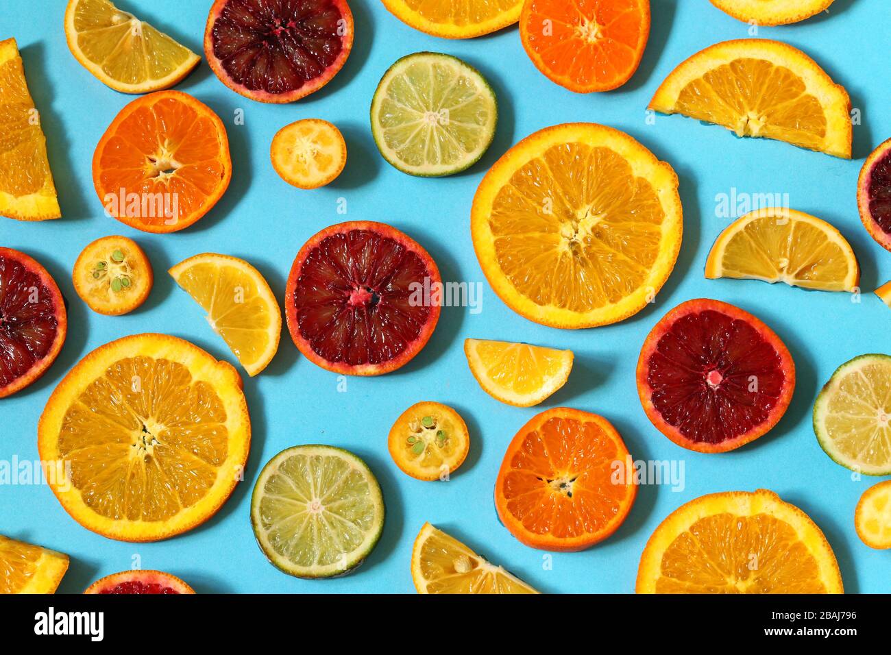 natural organic citrus fruits on a blue background Stock Photo - Alamy