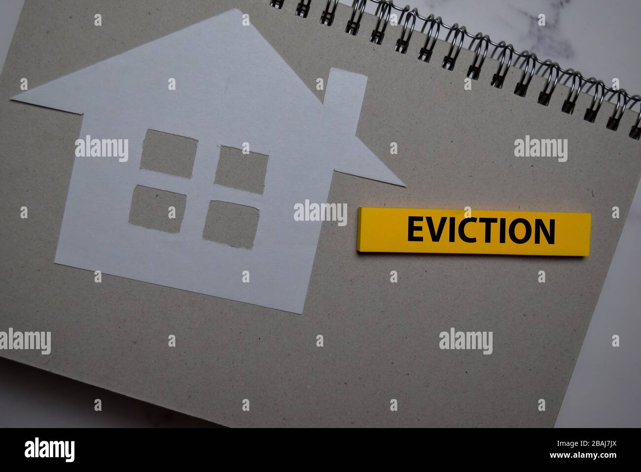 Eviction write on sticky note and house made from paper isolated on ...