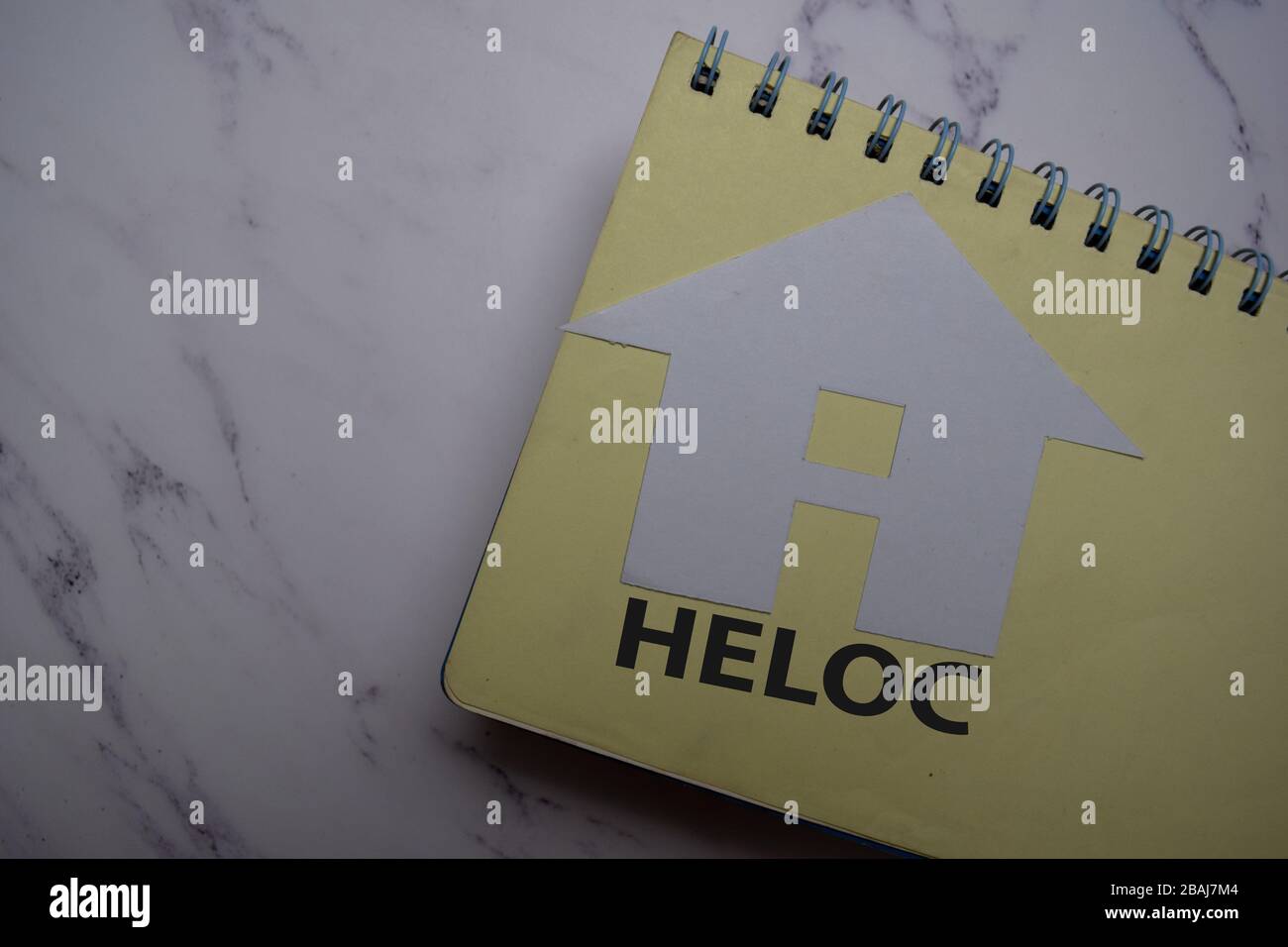 HELOC write on sticky note and house made from paper isolated on Office ...