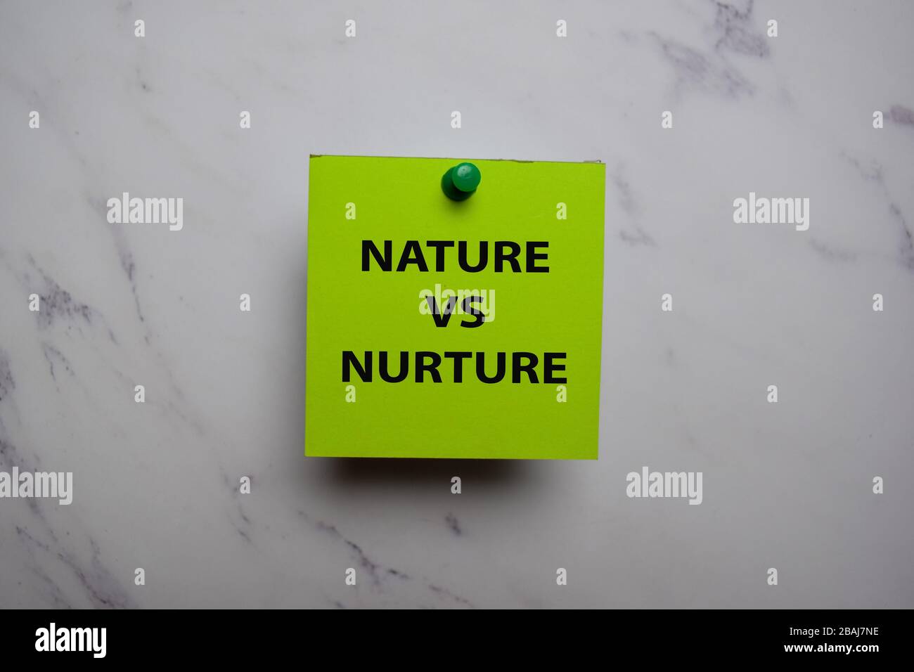Nature Vs Nurture write on sticky note isolated on Office Desk Stock ...