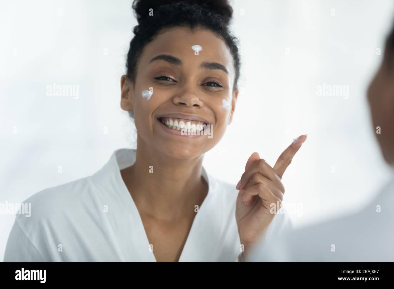 African woman applied cream on face caring about skin beauty Stock ...