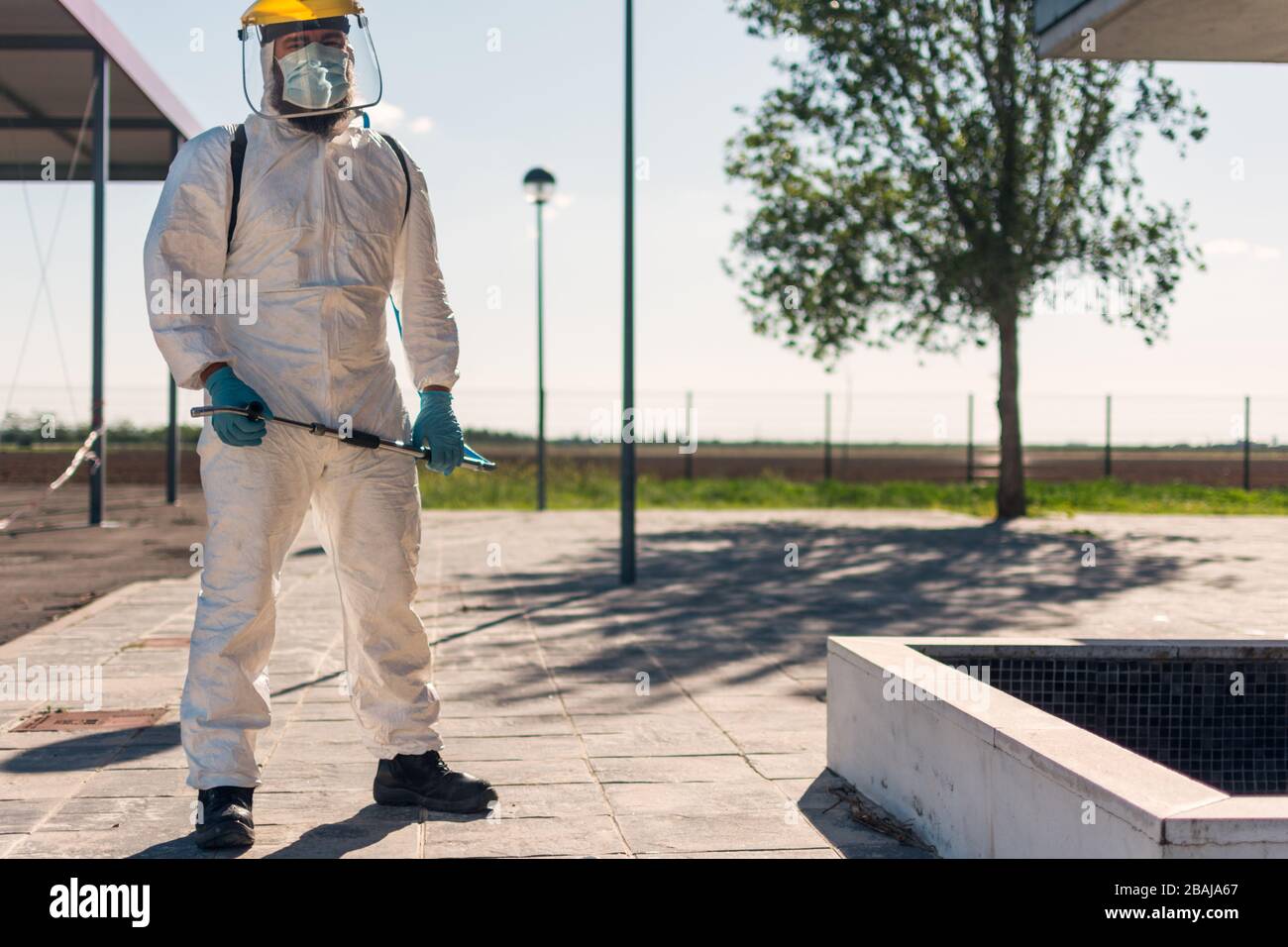 Man wearing an NBC personal protective equipment (ppe) suit, gloves ...