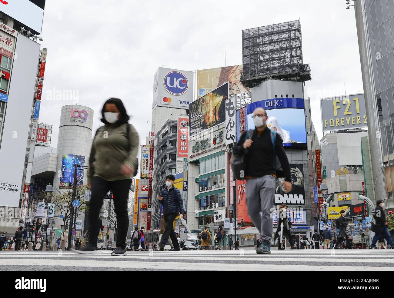 Tokyo, Japan. 28th March, 2020. A crossing in Tokyo's Shibuya area is ...