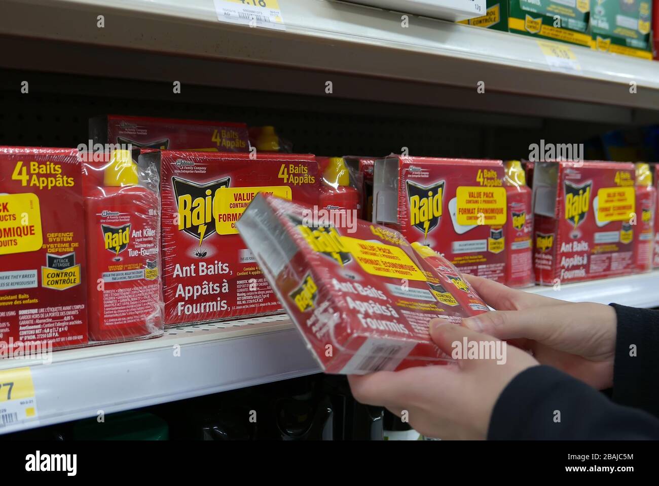 Woman buying Raid value pack inside Walmart store Stock Photo - Alamy