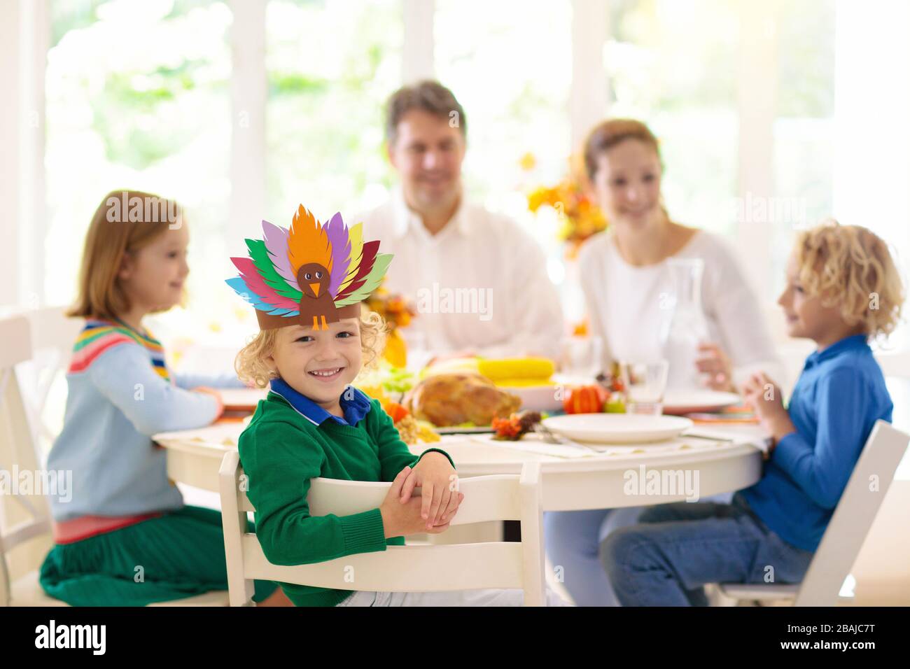 Family with kids eating Thanksgiving dinner. Roasted turkey and pumpkin ...
