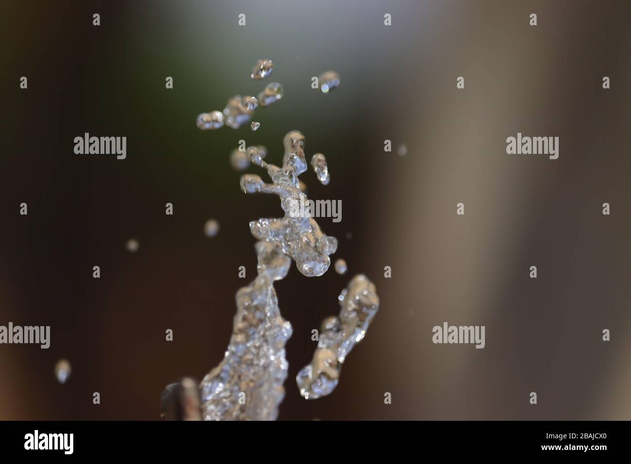 out of focus shot of water drop with blurred background and copy space ...