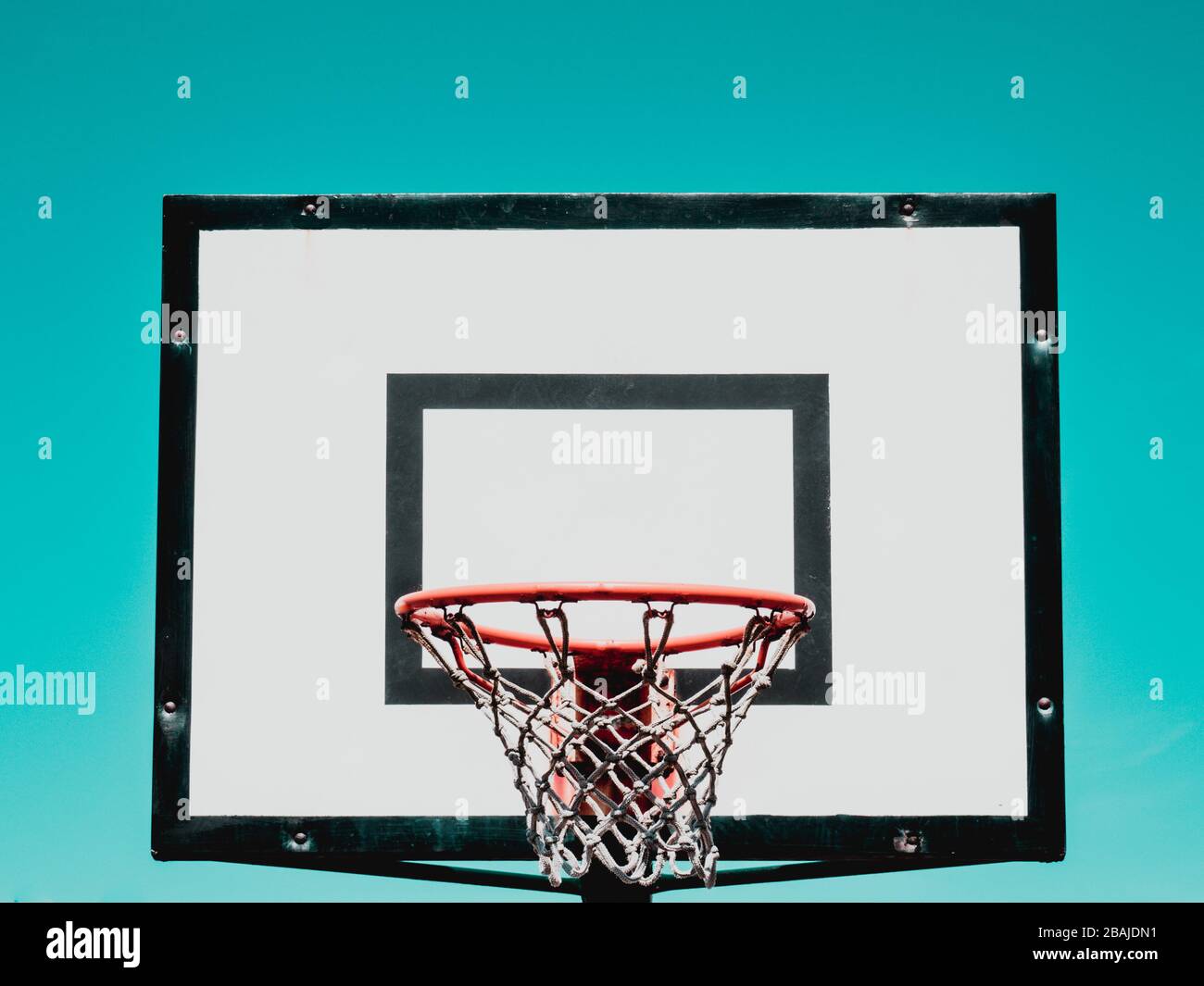 Basketball hoop on green background Stock Photo - Alamy