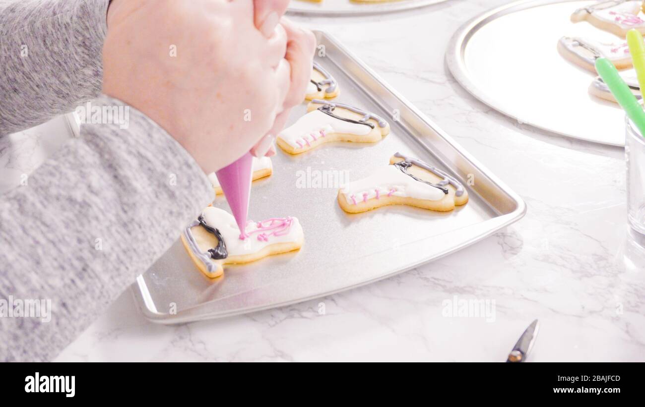 Icing figure skate shaped sugar cookies with royal icing Stock Photo ...