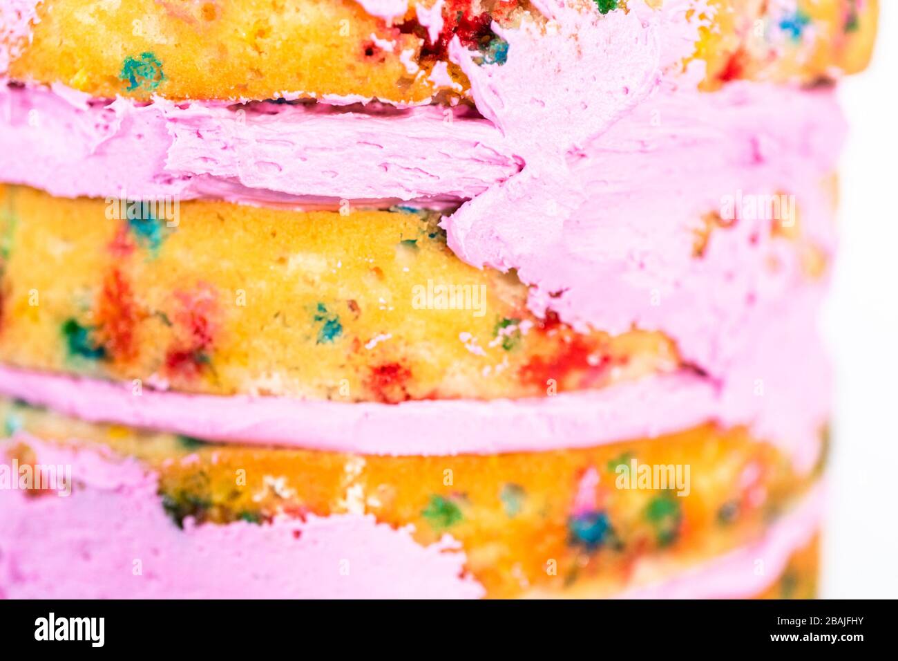 Funfetti cake layers with pink buttercream frosting Stock Photo - Alamy