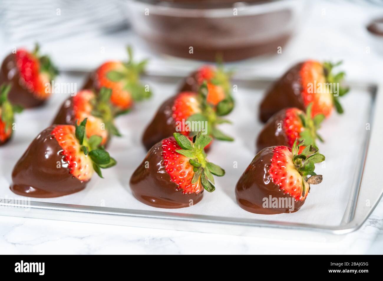 Making white and dark chocolate dipped strawberries Stock Photo - Alamy
