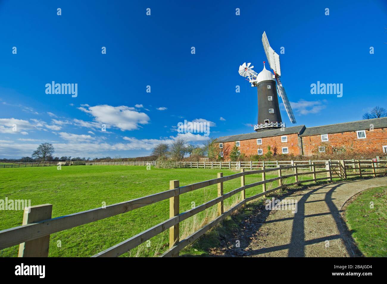 Old traditional working windmill in rural countryside landscape with ...
