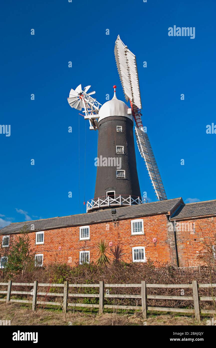 Old traditional working windmill in rural countryside landscape with ...