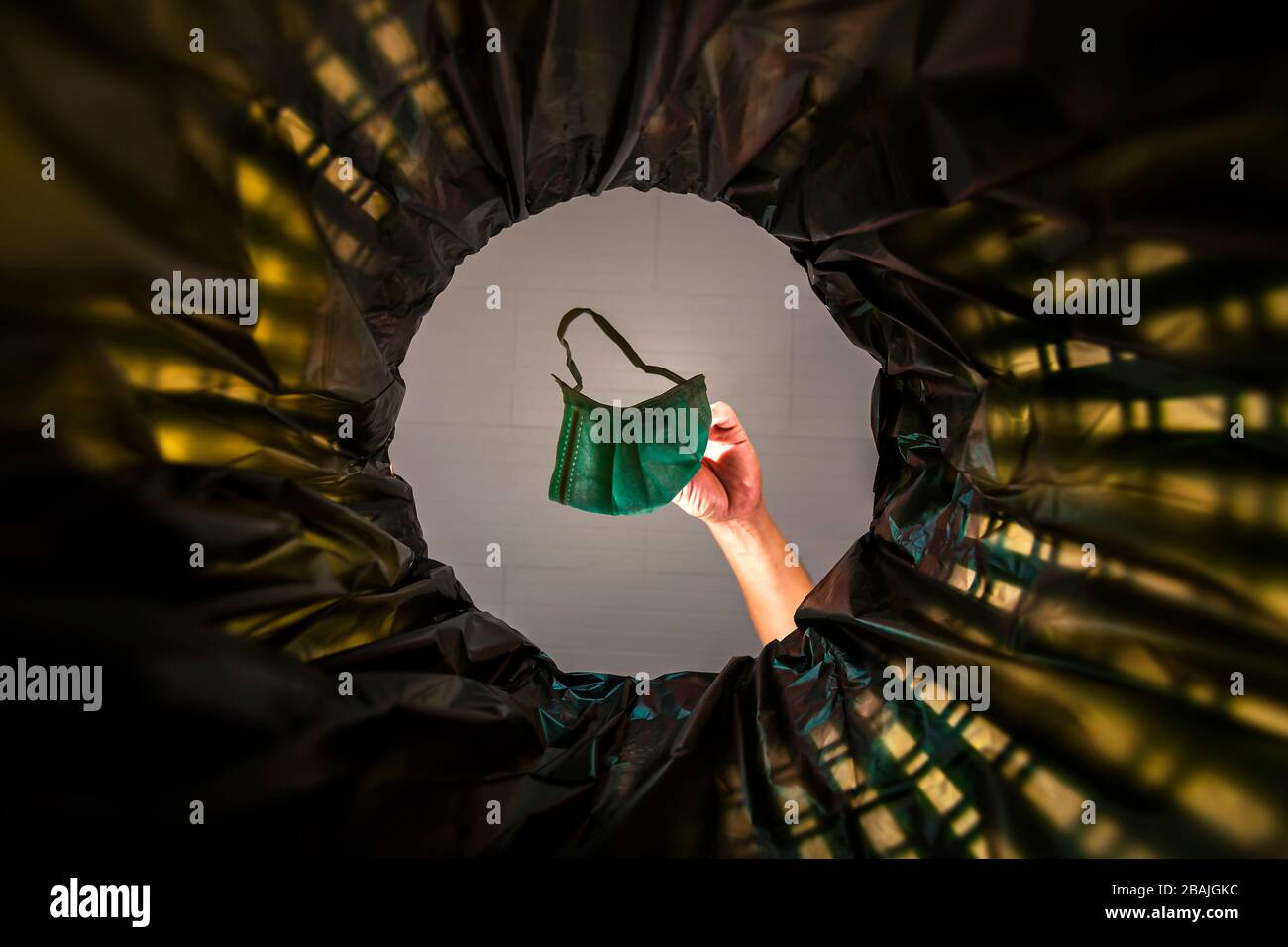 Throwing a face mask into the trash. With a worm view from the inside ...