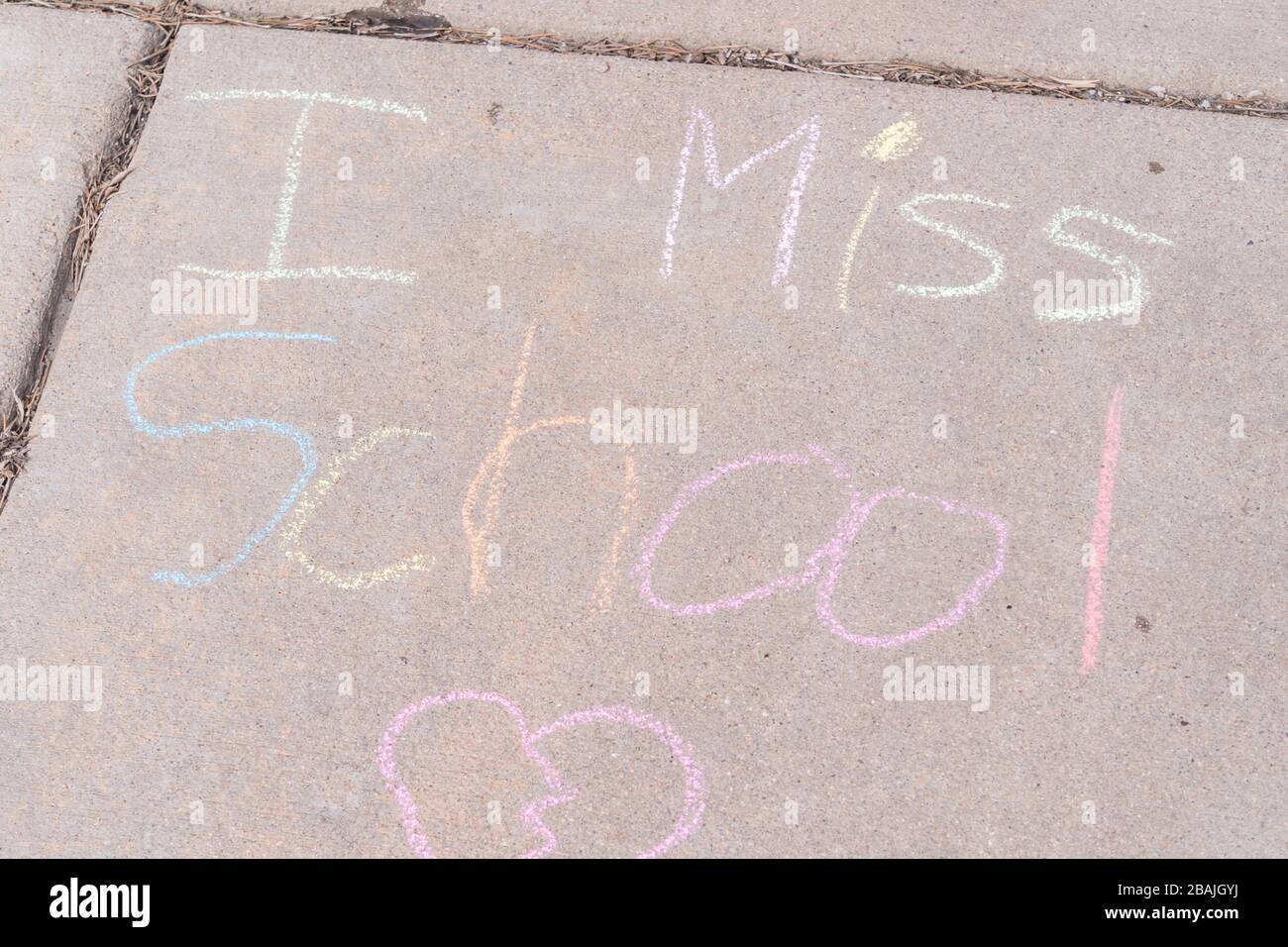 I miss school chalk sign in driveway Stock Photo - Alamy