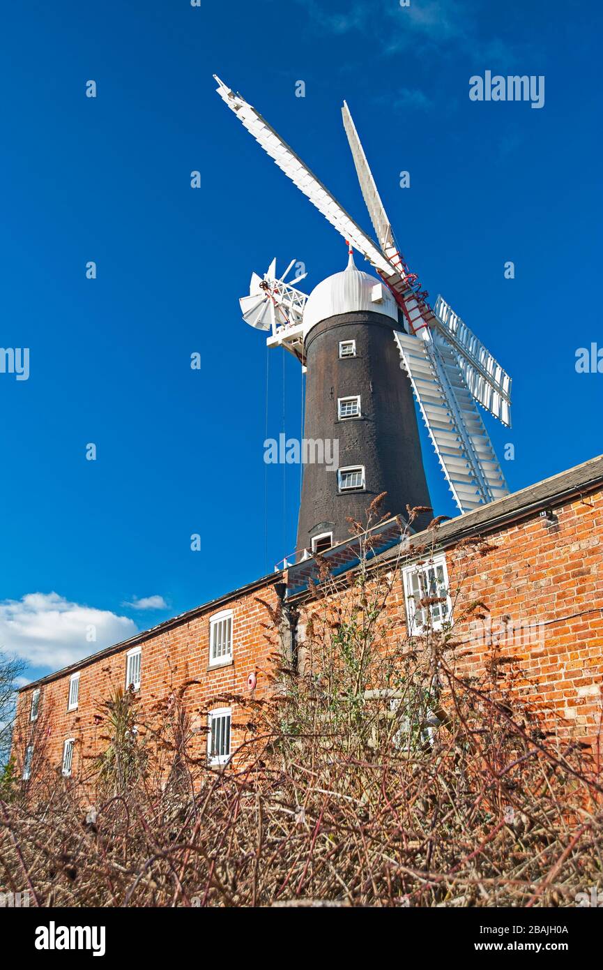 Old traditional working windmill in rural countryside landscape with ...