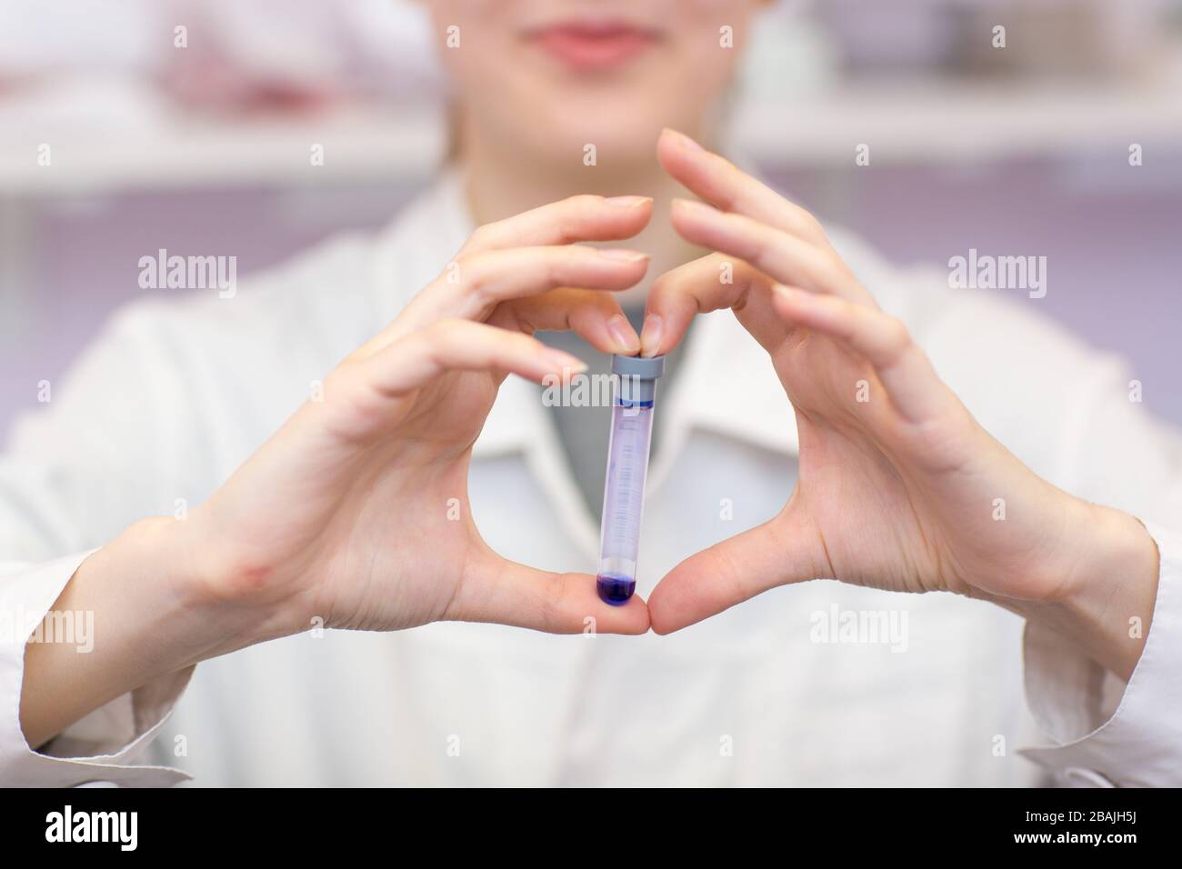 Woman lab technician holding test tube Stock Photo - Alamy