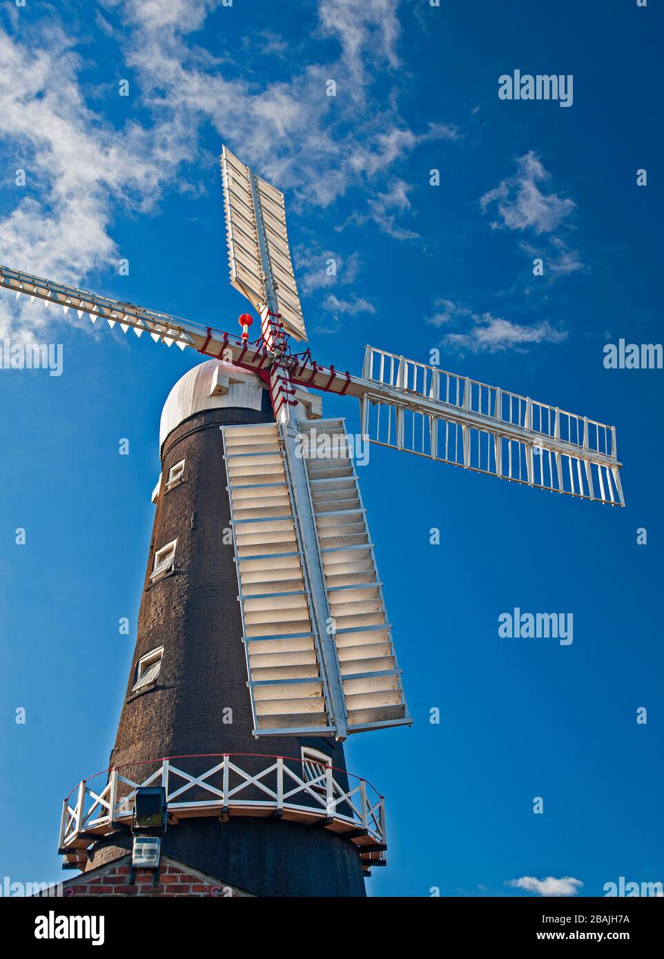 Old traditional working windmill in rural countryside landscape with ...