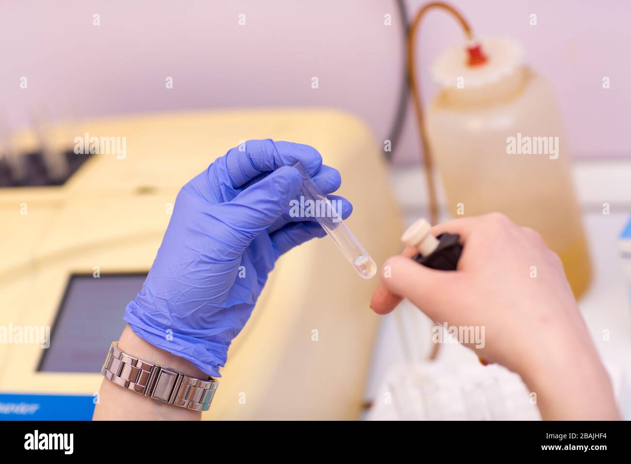 Laboratory assistant in medical laboratory holds test tube with blood ...