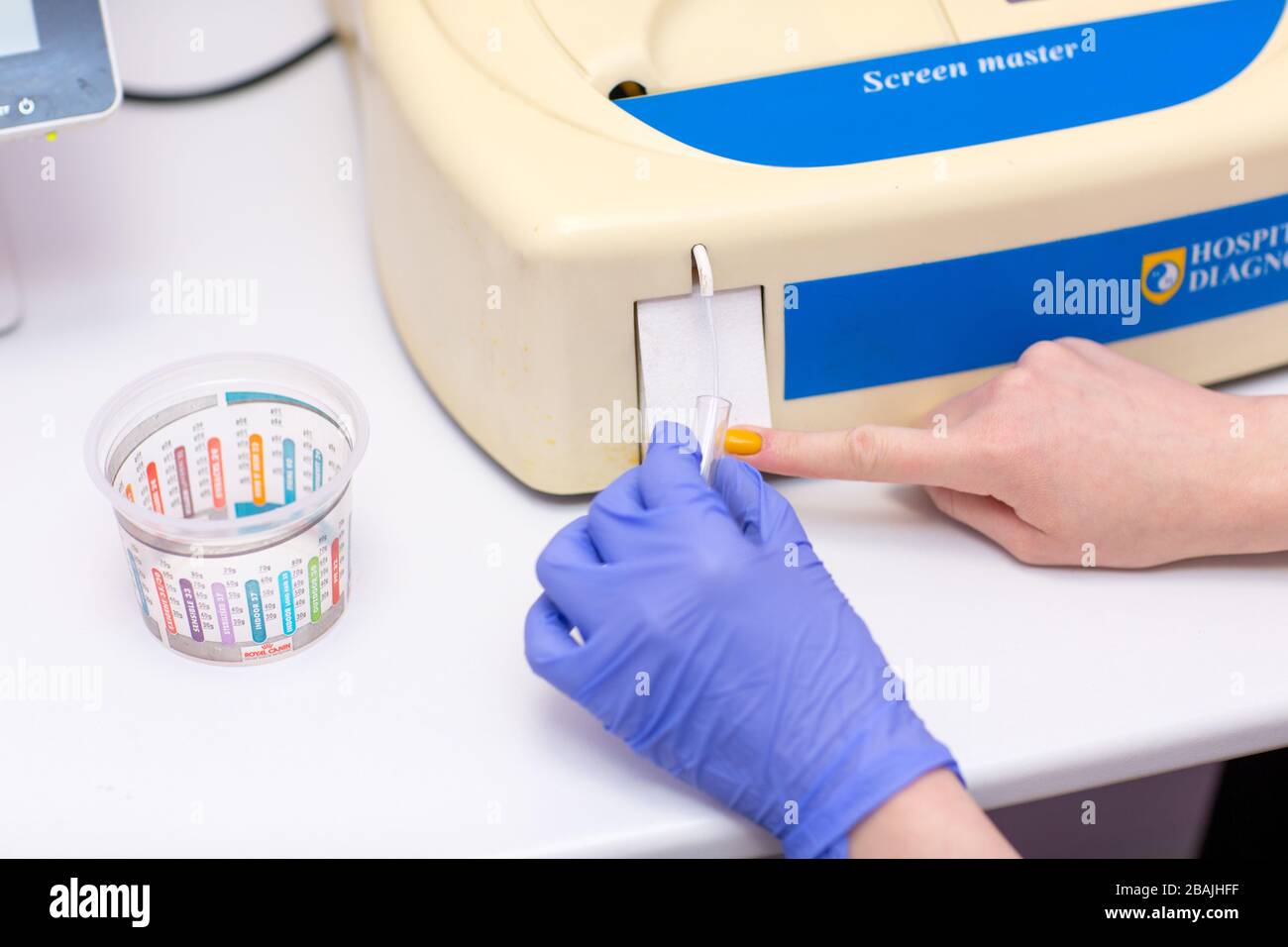 Laboratory assistant in medical laboratory holds test tube with blood ...