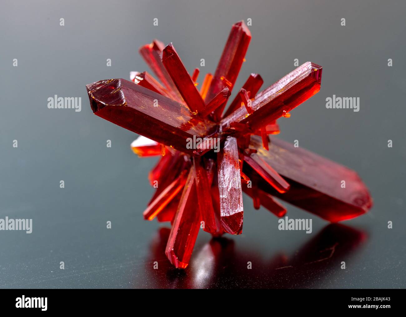 Red crystalline minerals on a black background Stock Photo - Alamy