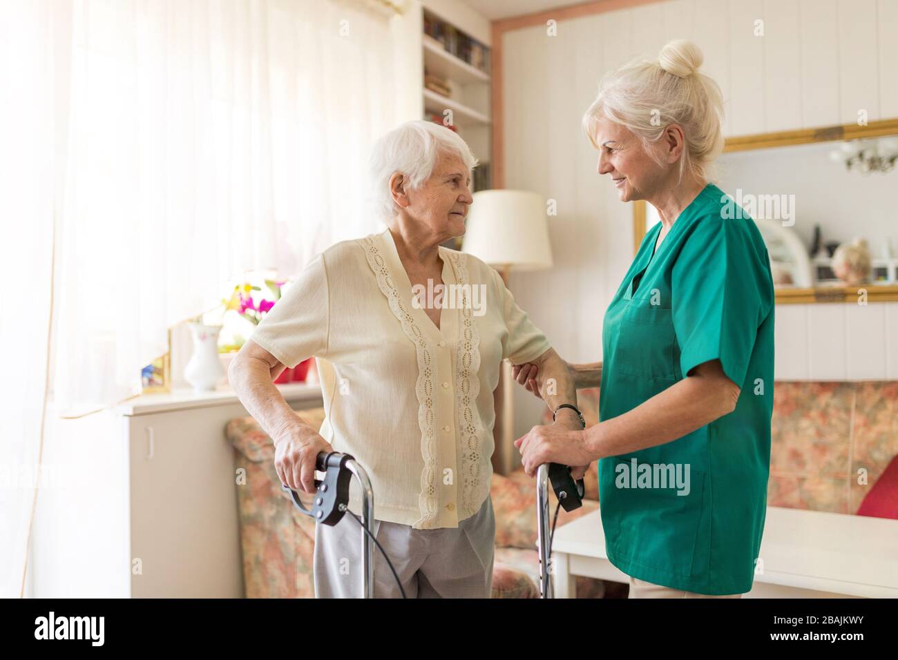 Home caregiver with senior adult woman Stock Photo - Alamy