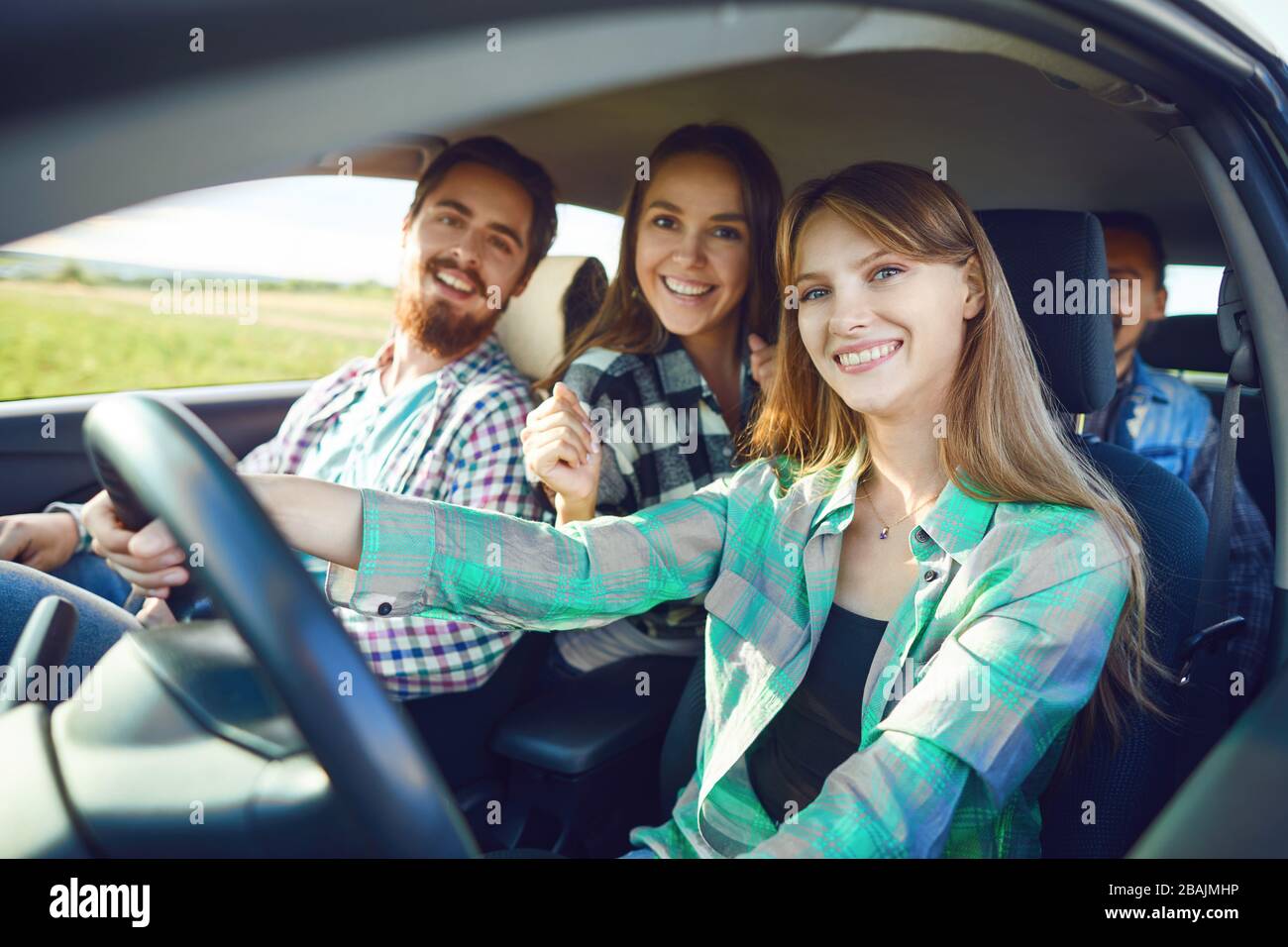 A group of happy friends are driving in a car Stock Photo - Alamy