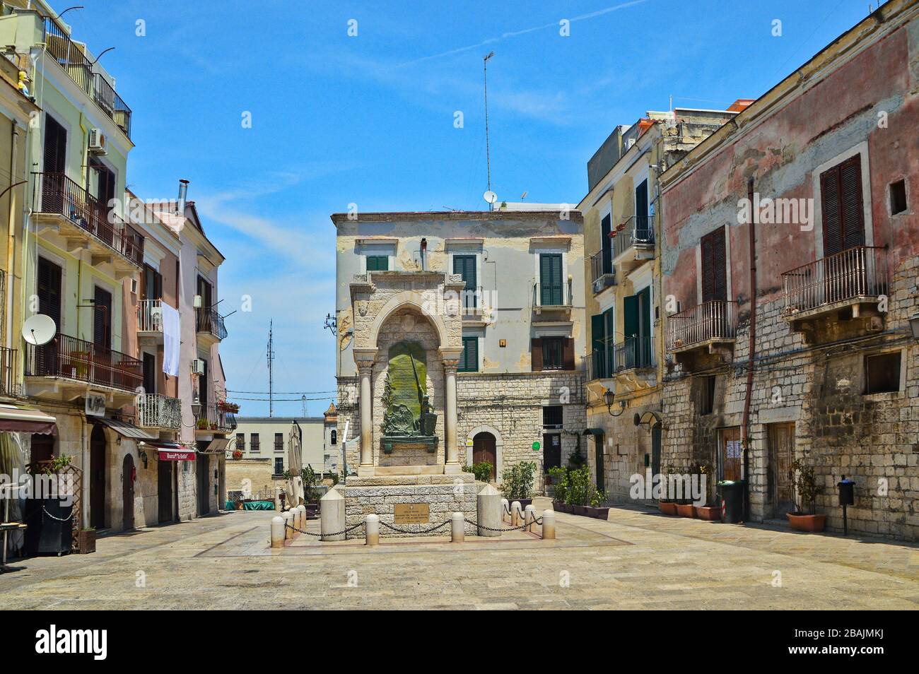 A narrow street between the old houses of Barletta, a town in the ...