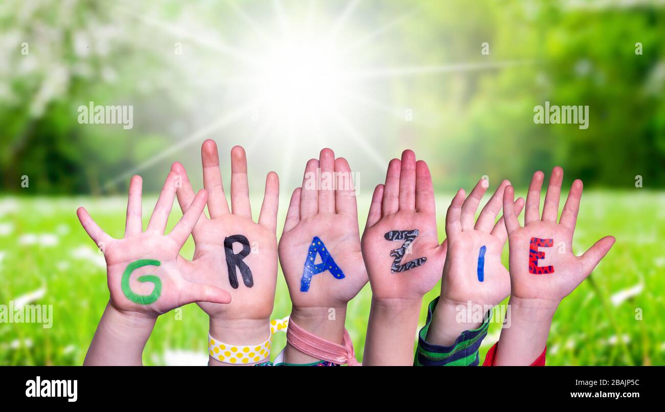 Children Hands Building Word Grazie Means Thank You, Grass Meadow Stock ... Children Hands Building Word Grazie Means Thank You, Grass Meadow Stock ...