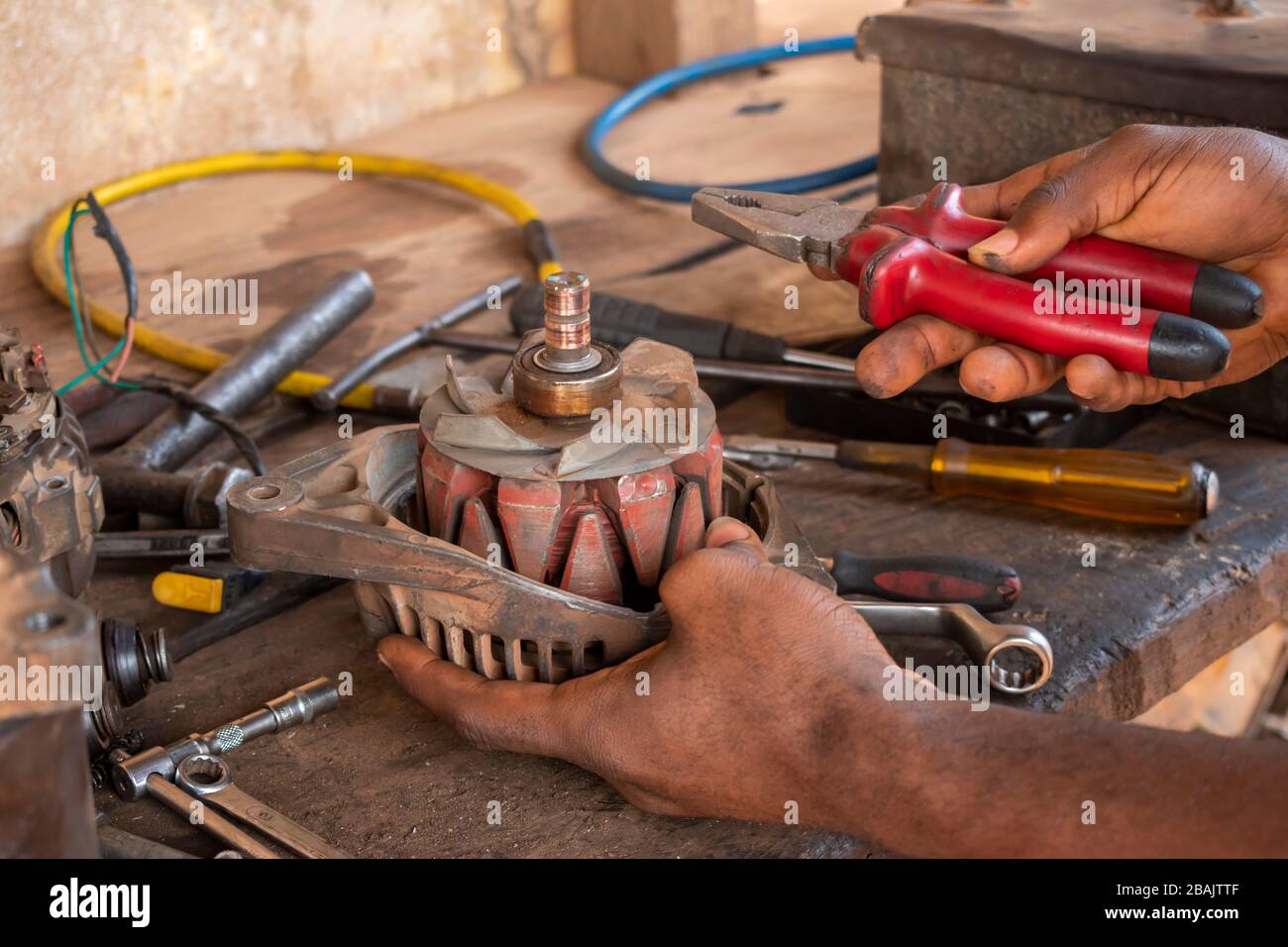 hand working on a coil and tools on a mechanical table Stock Photo - Alamy
