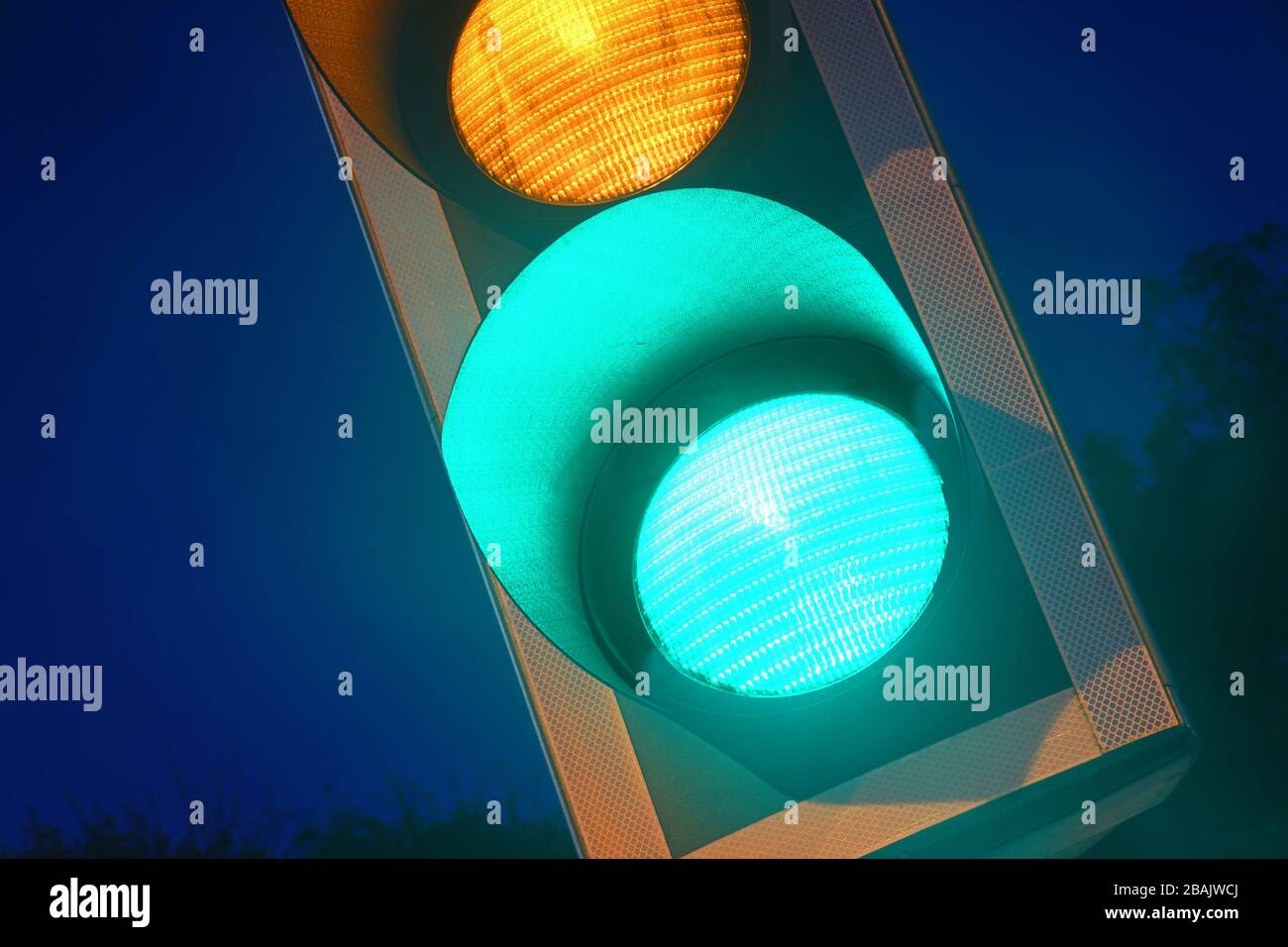green traffic light on road at twilight united kingdom Stock Photo - Alamy